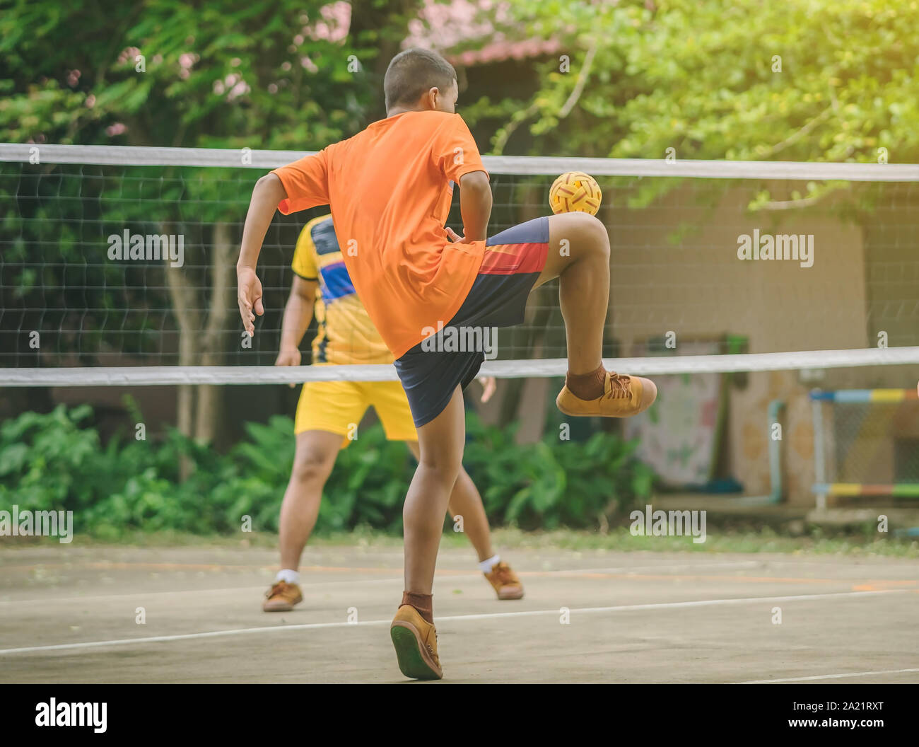 Students playing traditional asian sport game sepak takraw in school ...