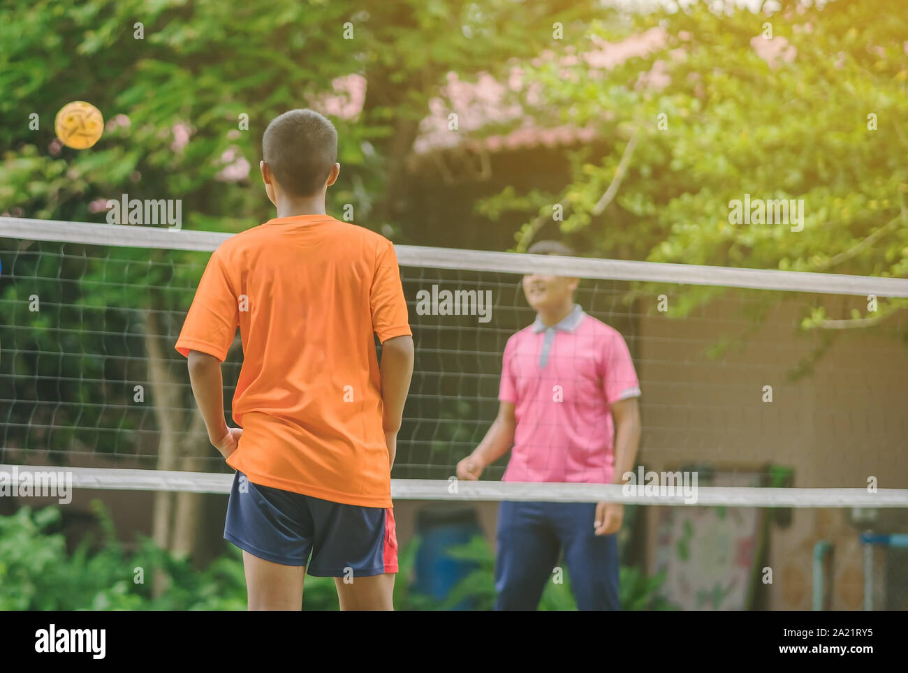 Students playing traditional asian sport game sepak takraw in school ...