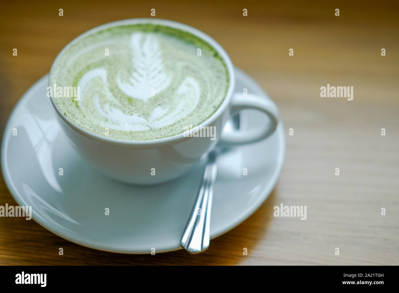 hot matcha green tea latte on wood table. delicious beverage Stock ...