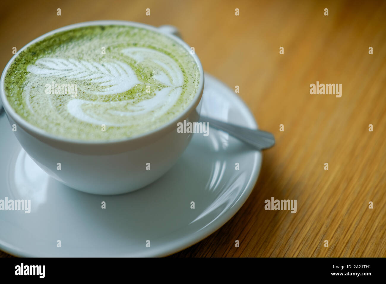 hot matcha green tea latte on wood table. delicious beverage Stock ...