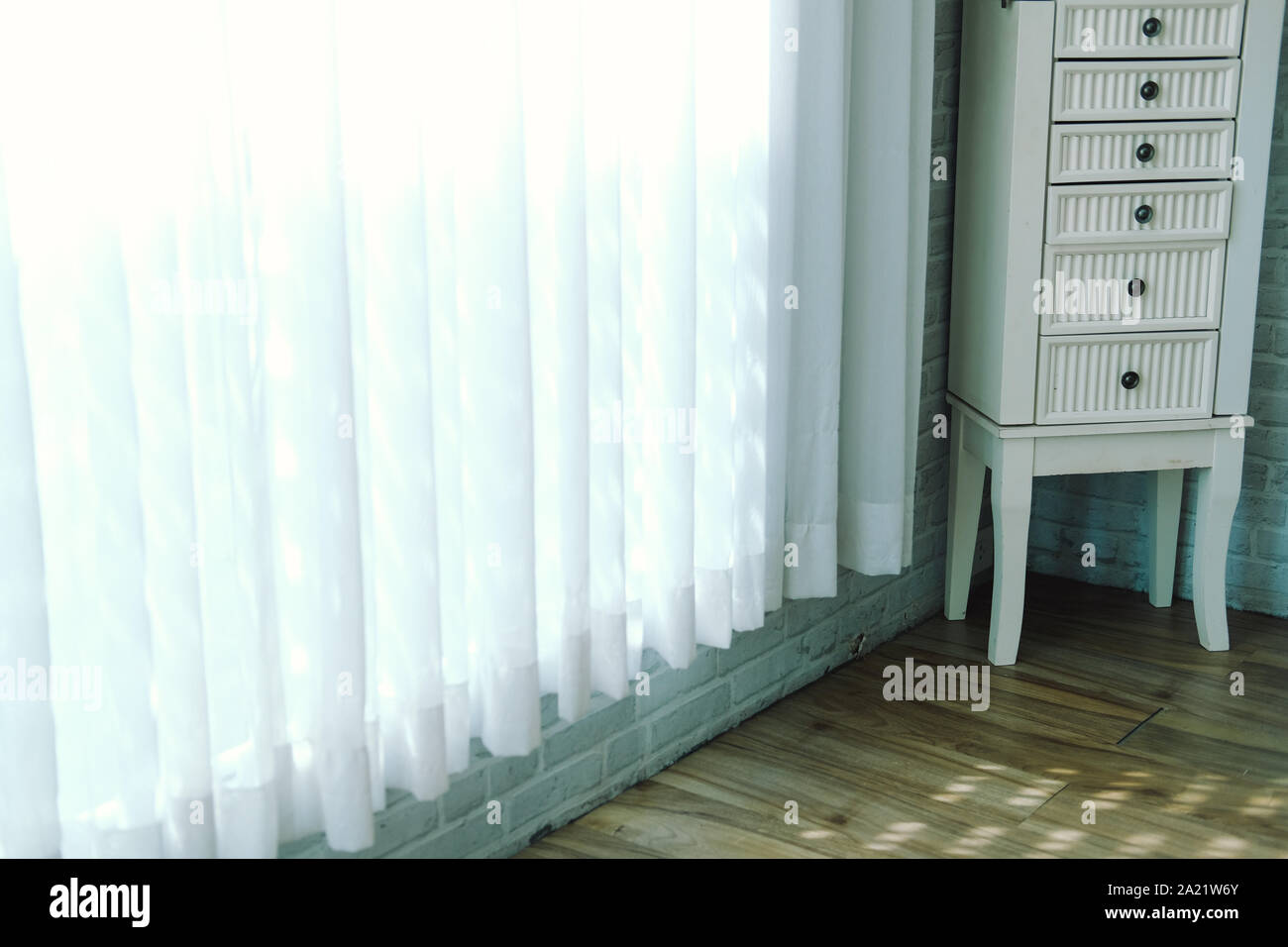 white cabinet with drawer & see through sheer window curtain at home ...