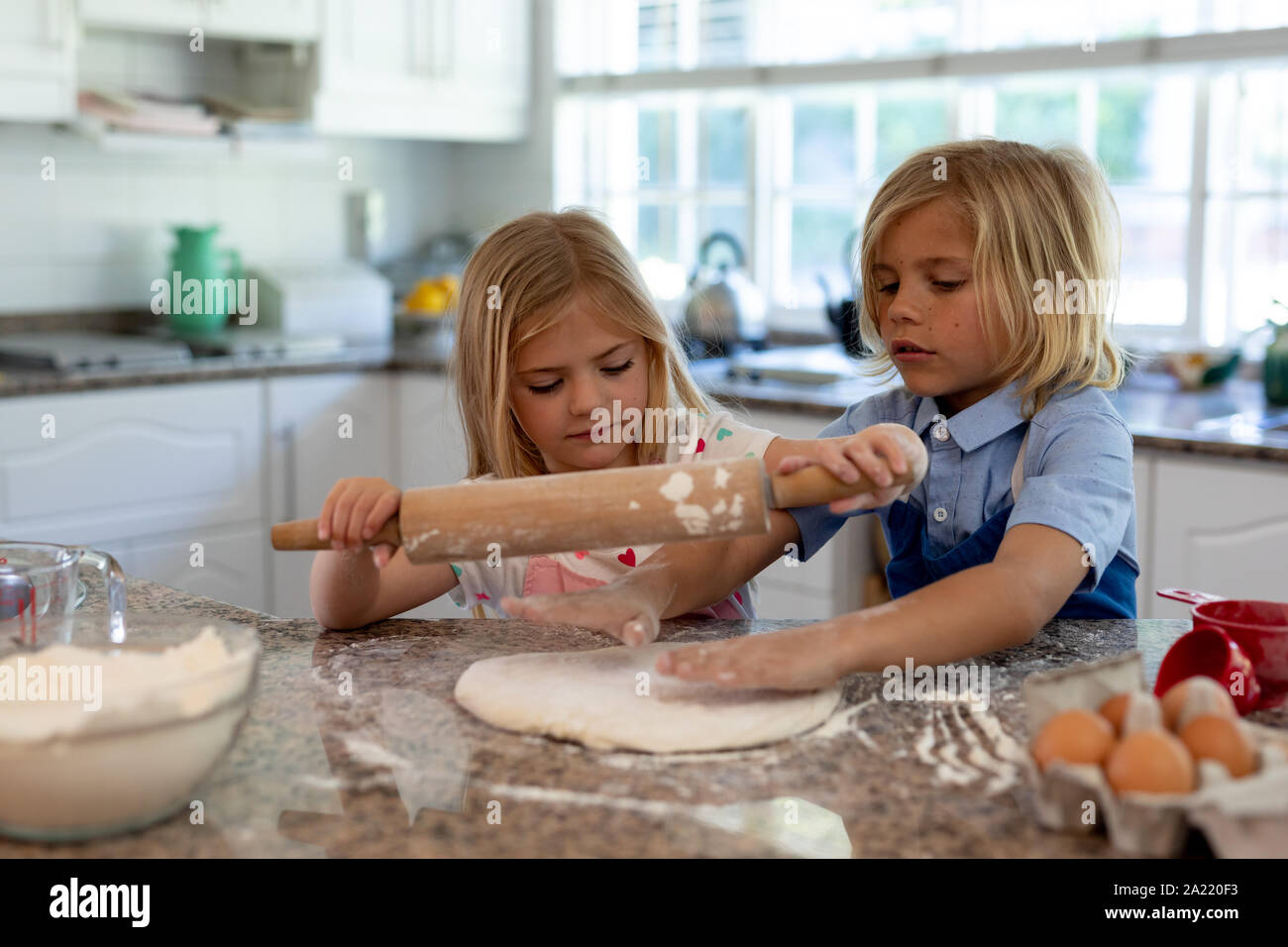 Brother and sister making Christmas cookies at home Stock Photo - Alamy