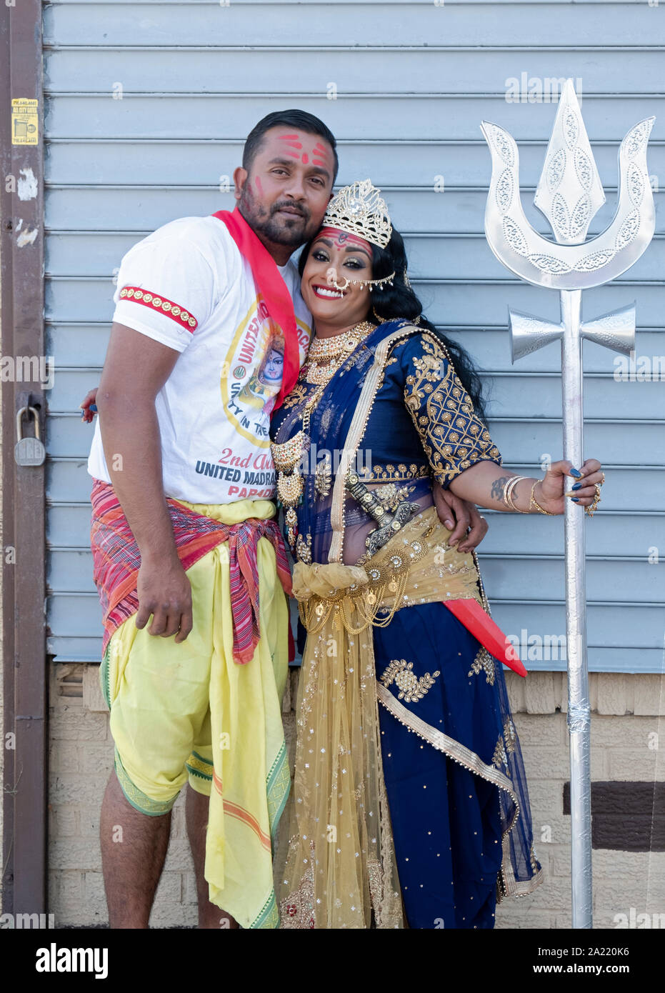 A married Hindu couple in costumes pose for a portrait at the Madrassi ...