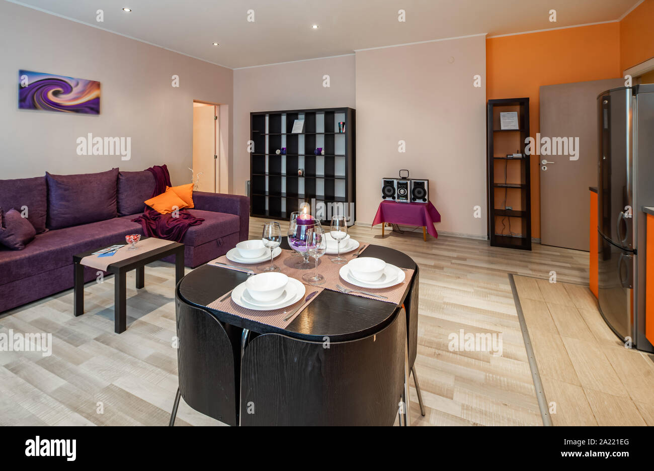 Cozy sofa. Shelves. Laminate floor. Served table. Blurred picture Stock ...