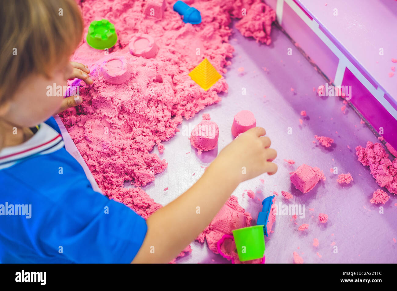 Boy playing with kinetic sand in preschool. The development of fine ...