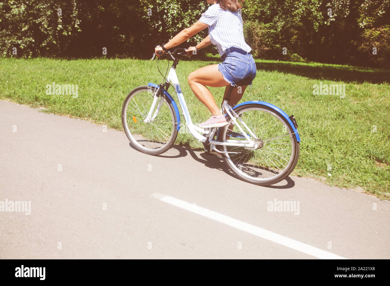 Back view girl riding bicycle hi-res stock photography and images - Alamy