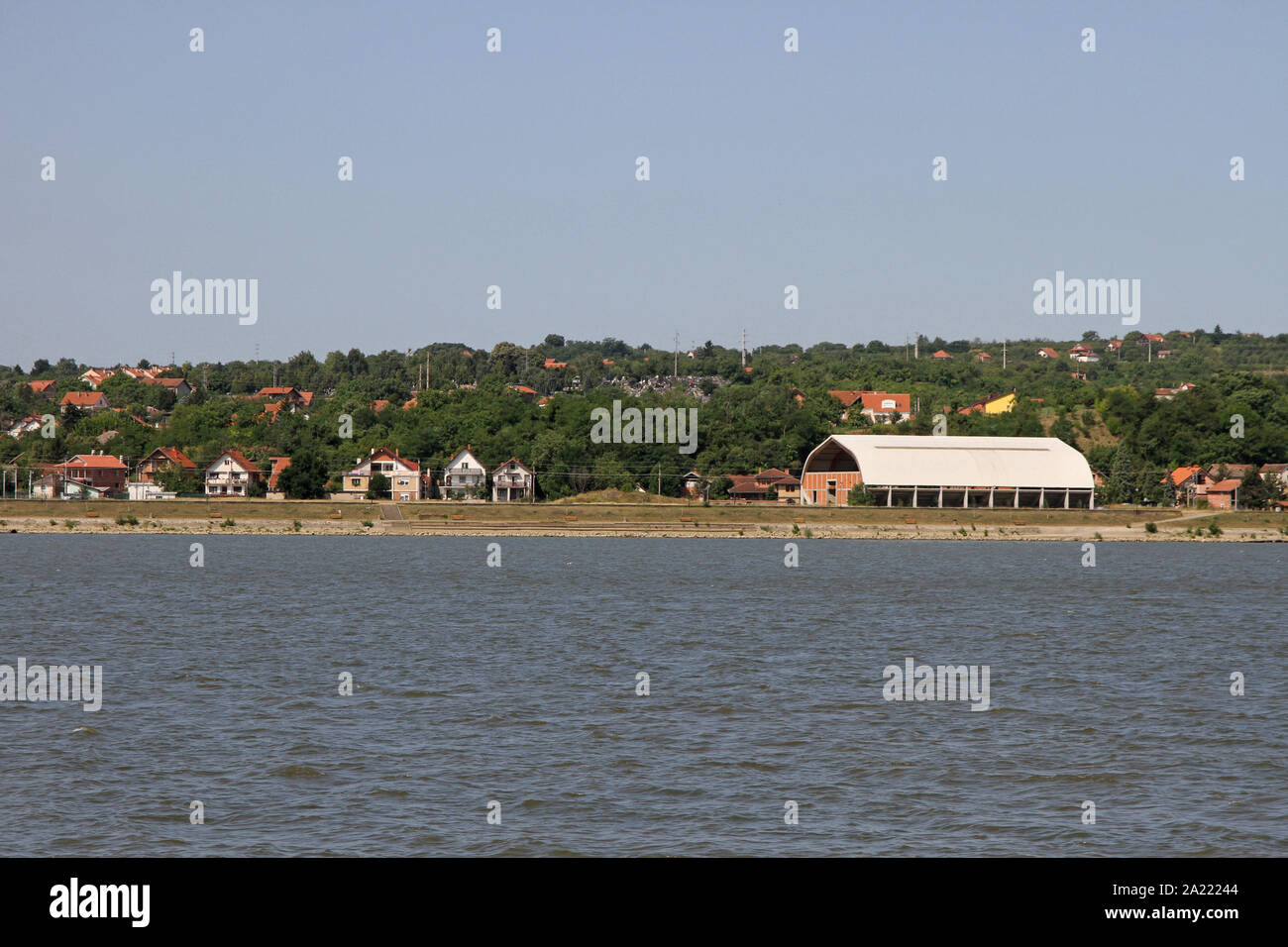 Warehouses, houses and vegetation on the Danube River bank, Panchevo ...