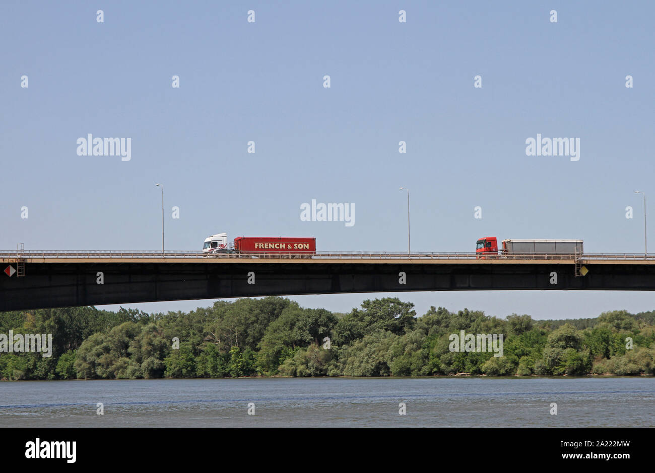 Closer side view of the Route 14 bridge with trucks transporting goods ...