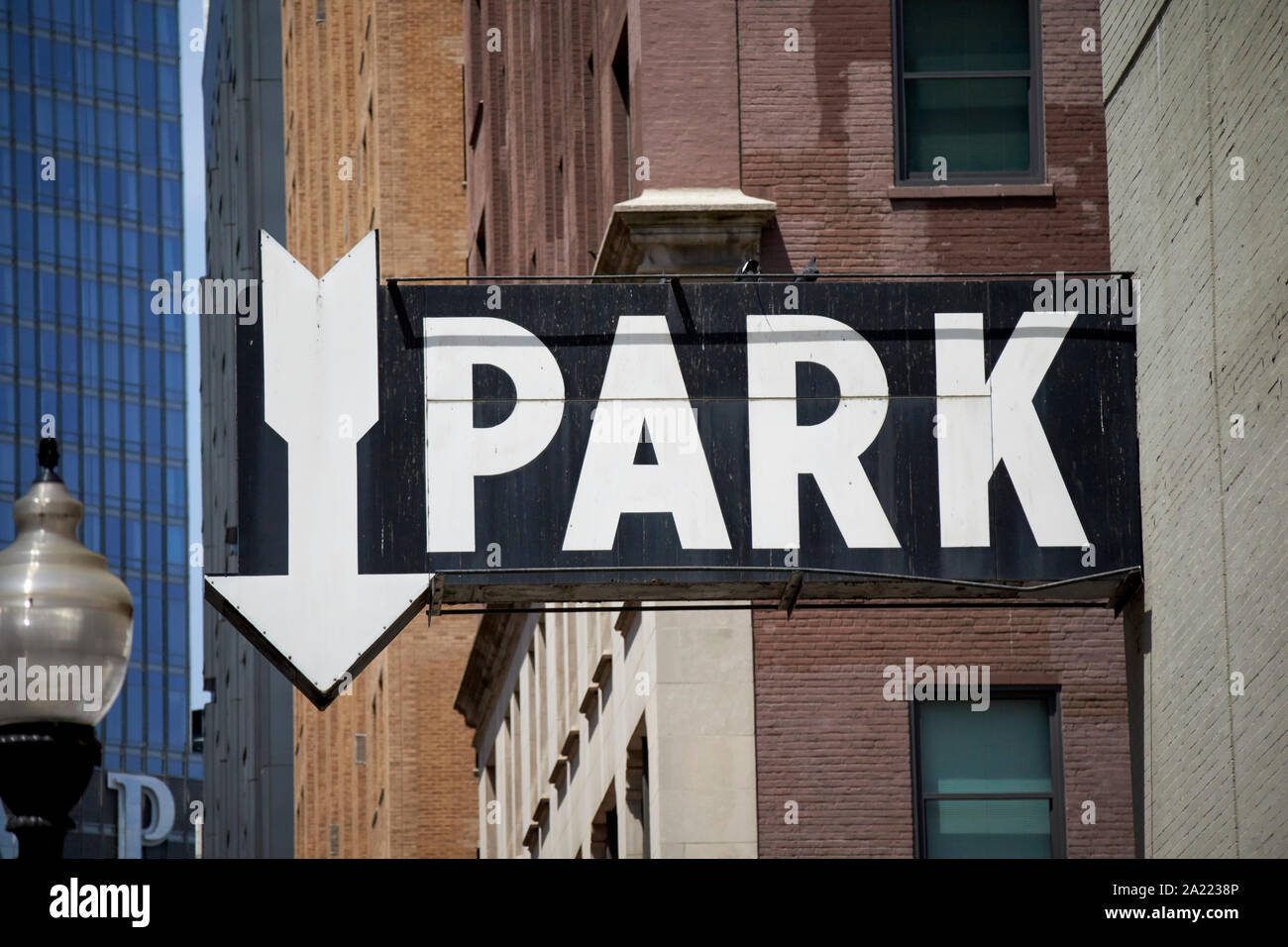 old style parking garage park sign with down arrow on the side of a ...