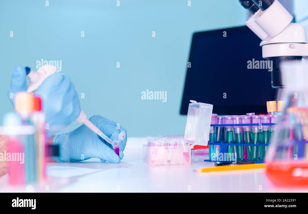 Scientific experiment in microbiological lab. Microscope and test tube ...