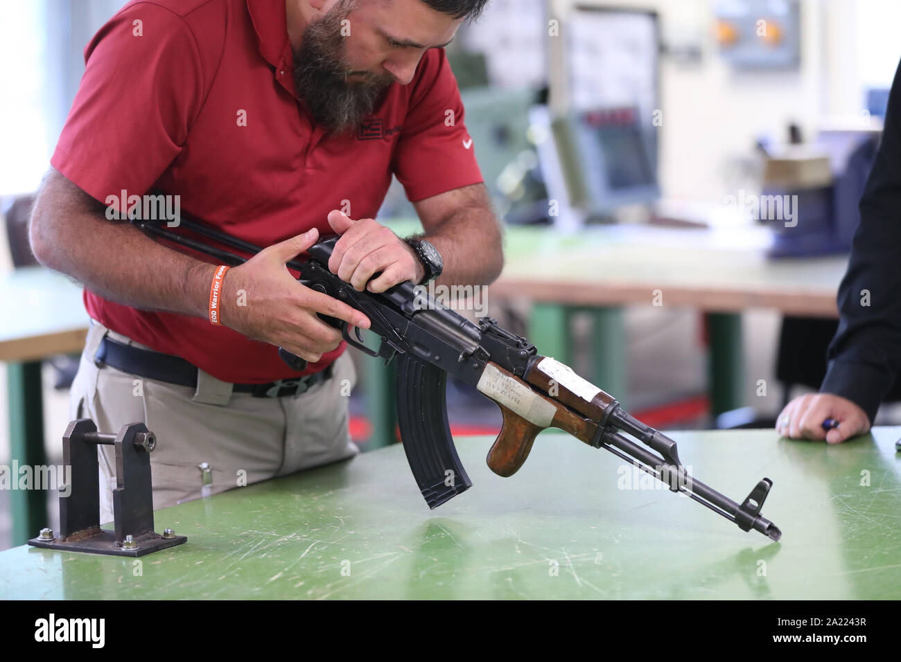 Students learn how to strip and make safe a Kalashnikov rifle during in ...