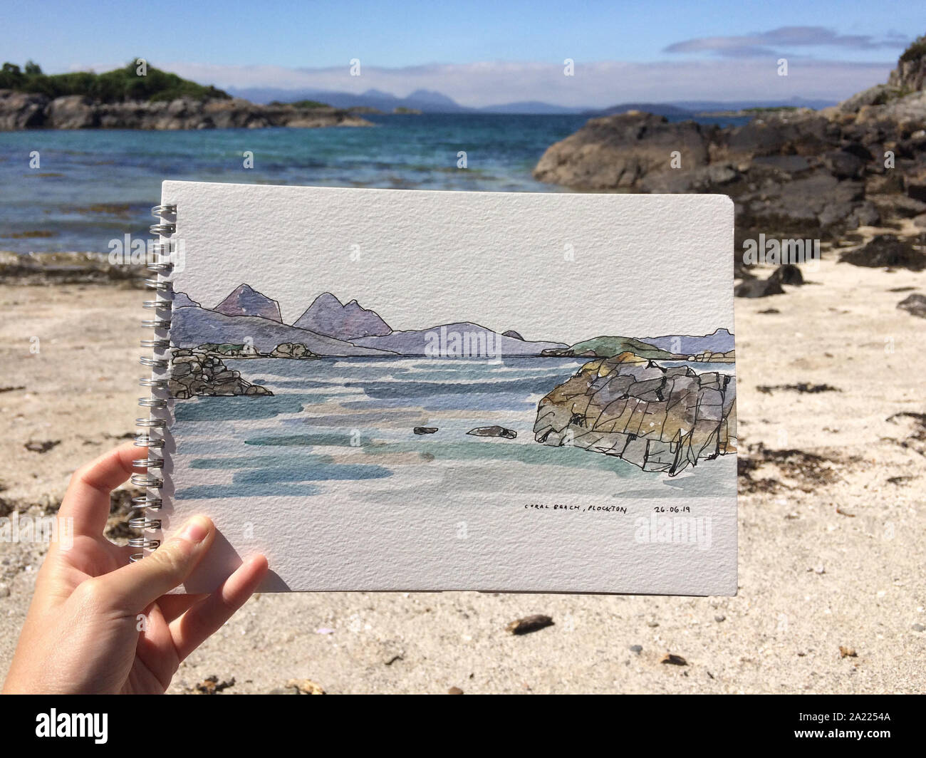 Painting of the view from coral beach near Plockton, held up in front ...