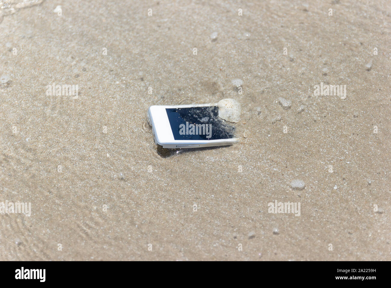 White Mobile phone floated to the sea at the beach Stock Photo - Alamy