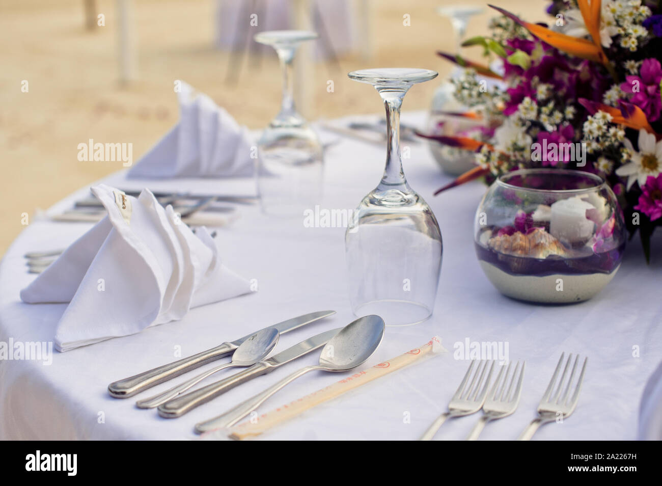 Romantic dinner setting on the beach at sunset Stock Photo - Alamy