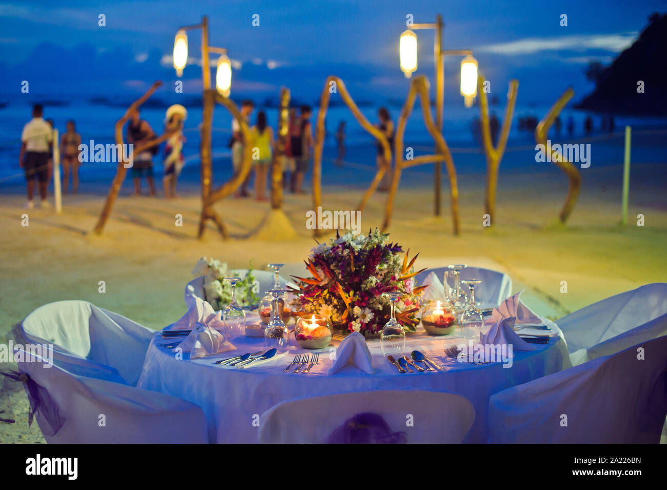 Romantic dinner setting on the beach at sunset Stock Photo - Alamy