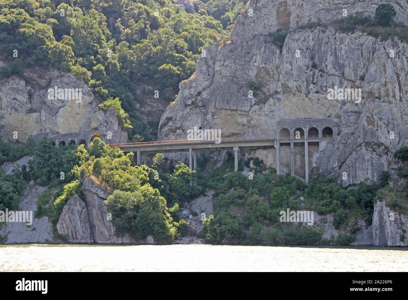 The Route 34 highway bridge and tunnel with arches running over side of ...