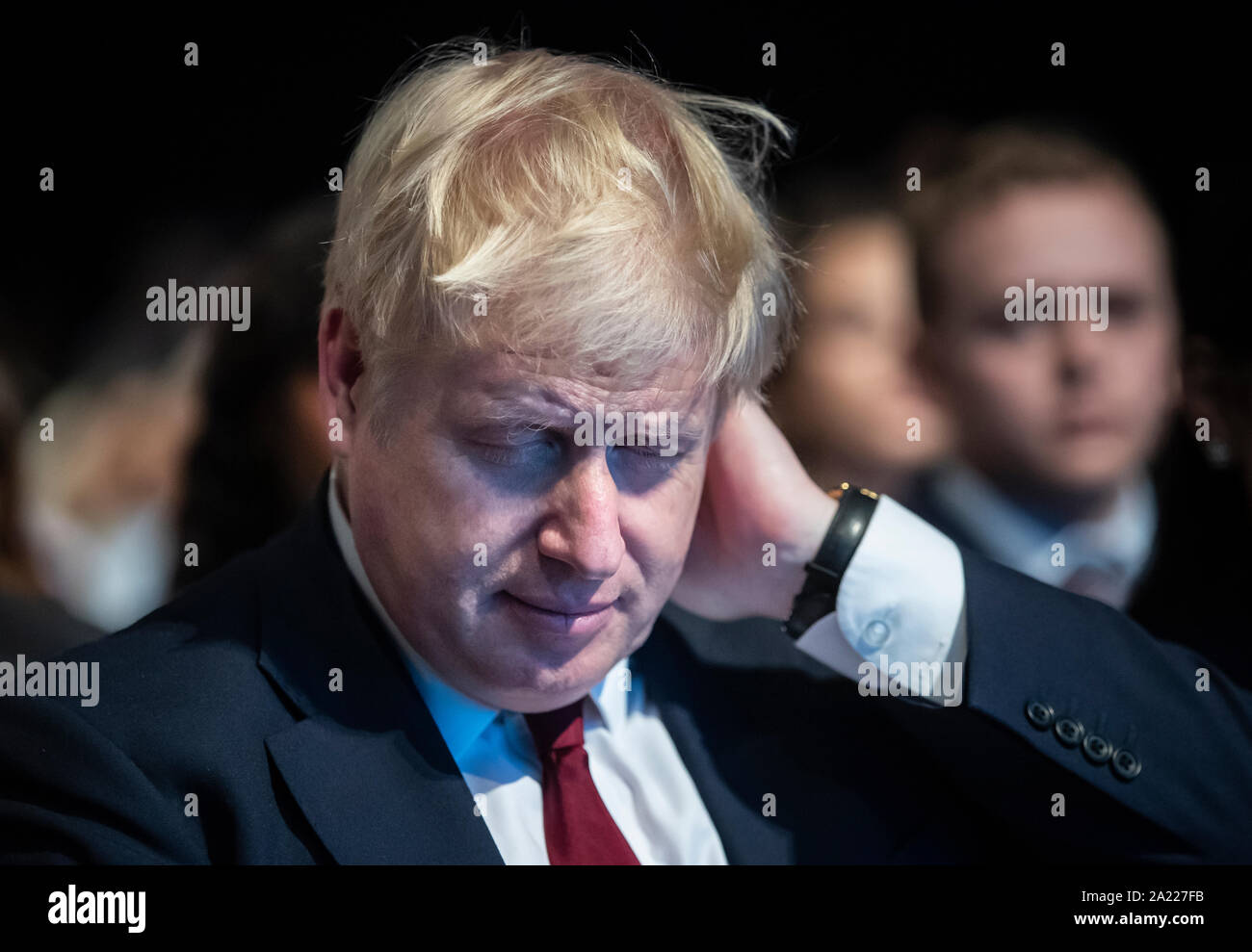 Prime Minister Boris Johnson sits in the audience at the Conservative ...