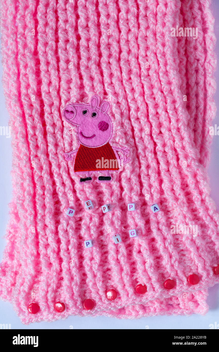 Girl's hand knitted pink Peppa Pig scarf with motif and beads on Stock ...