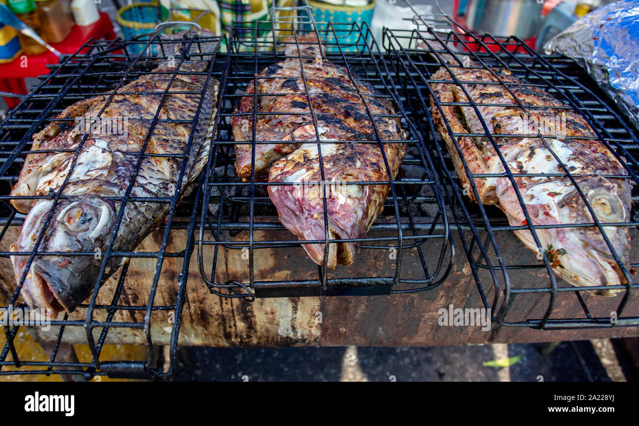 Tree fish prepared on barbecue Stock Photo - Alamy