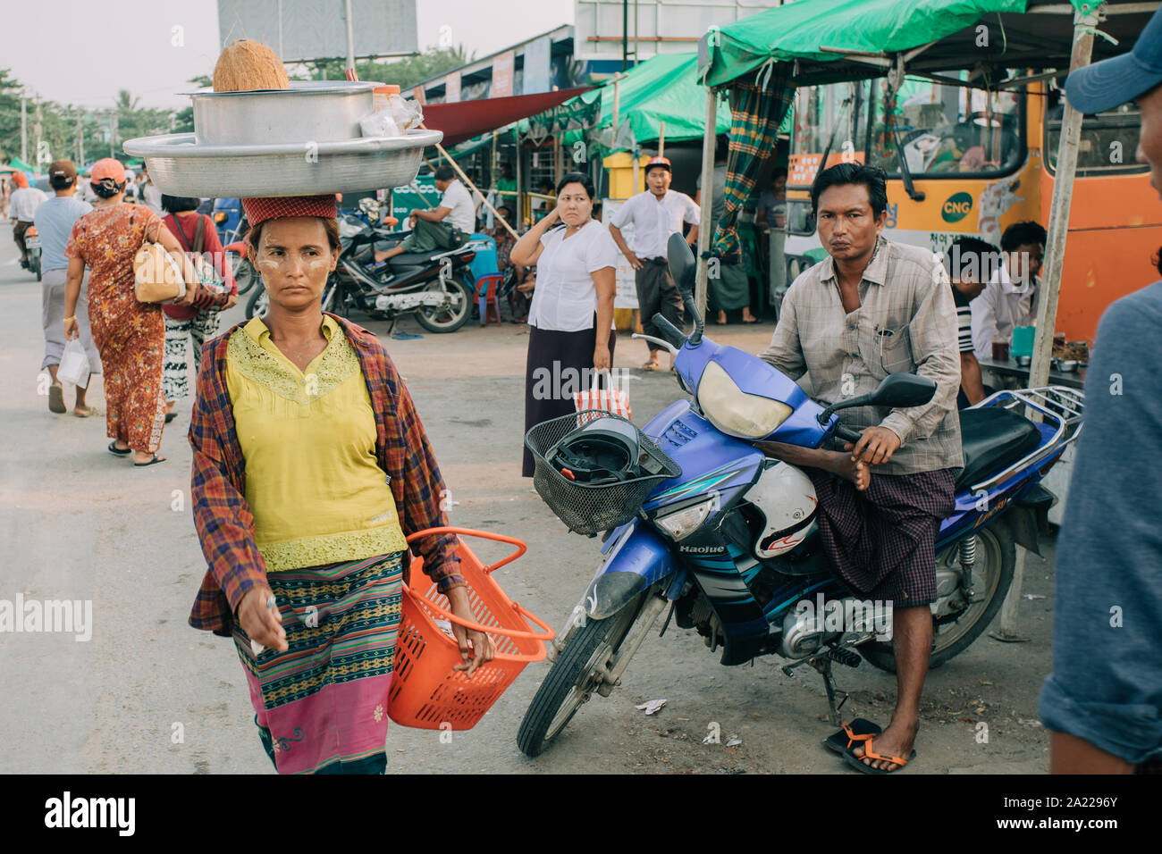Woman carry weight on the head. Street vendor female with bowl on the ...