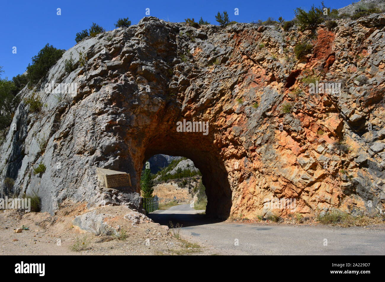 Rock gate as a village entry in the mountains Stock Photo - Alamy