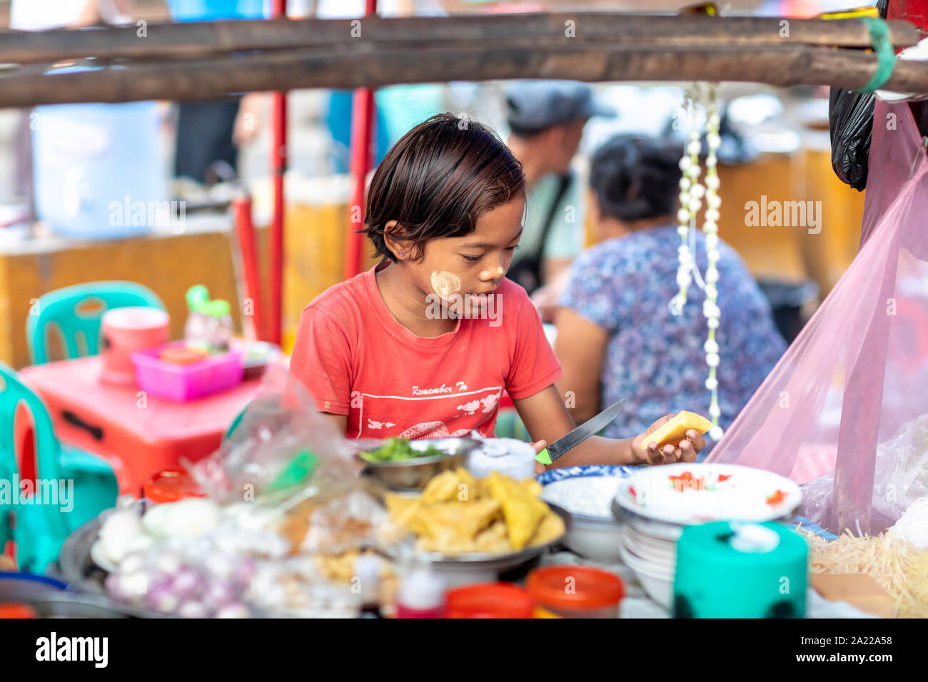 Young burmese boy preparing traditional street food at Yangon. Children ...