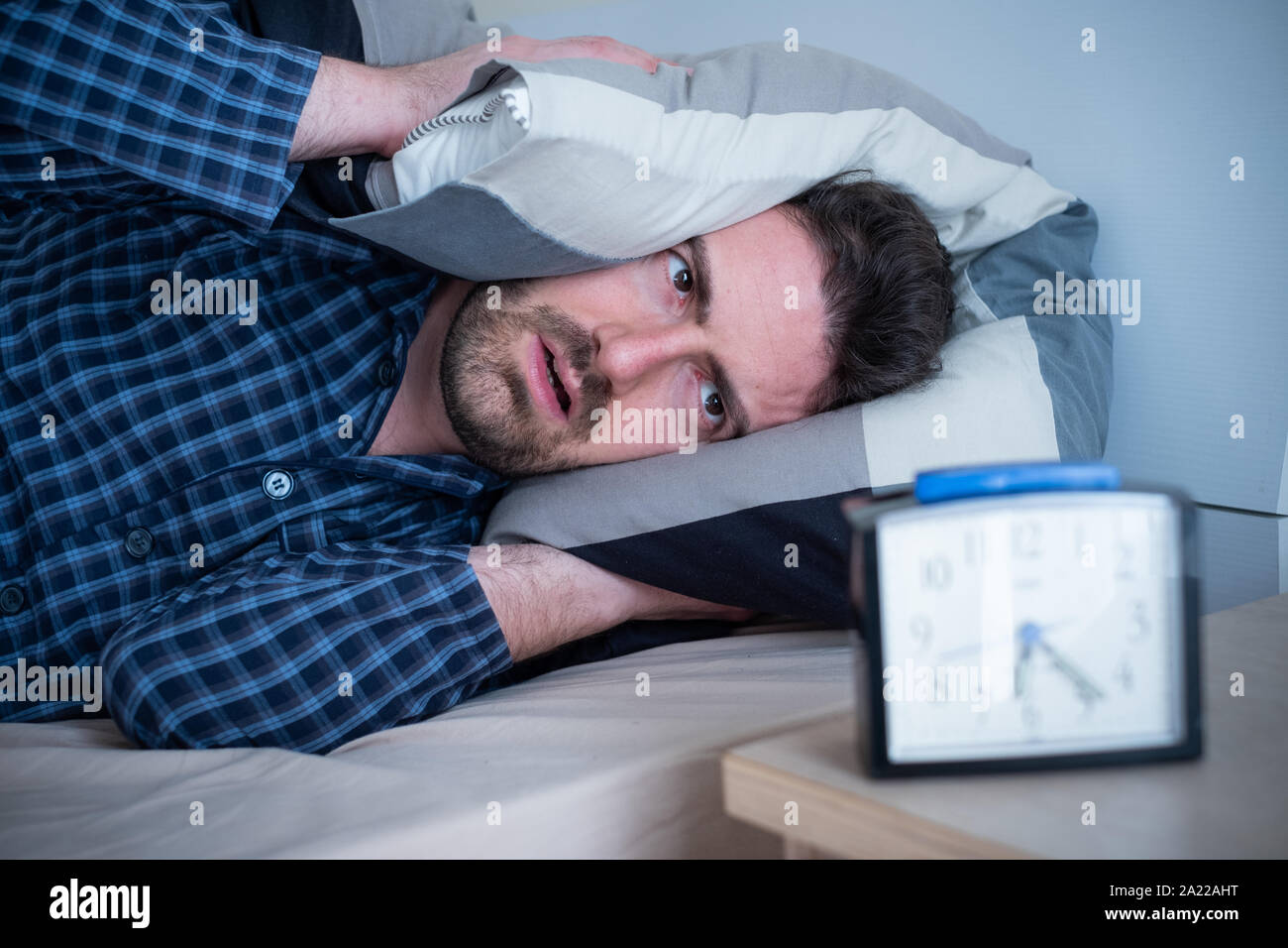 Man sleeping bed alarm hi-res stock photography and images - Alamy