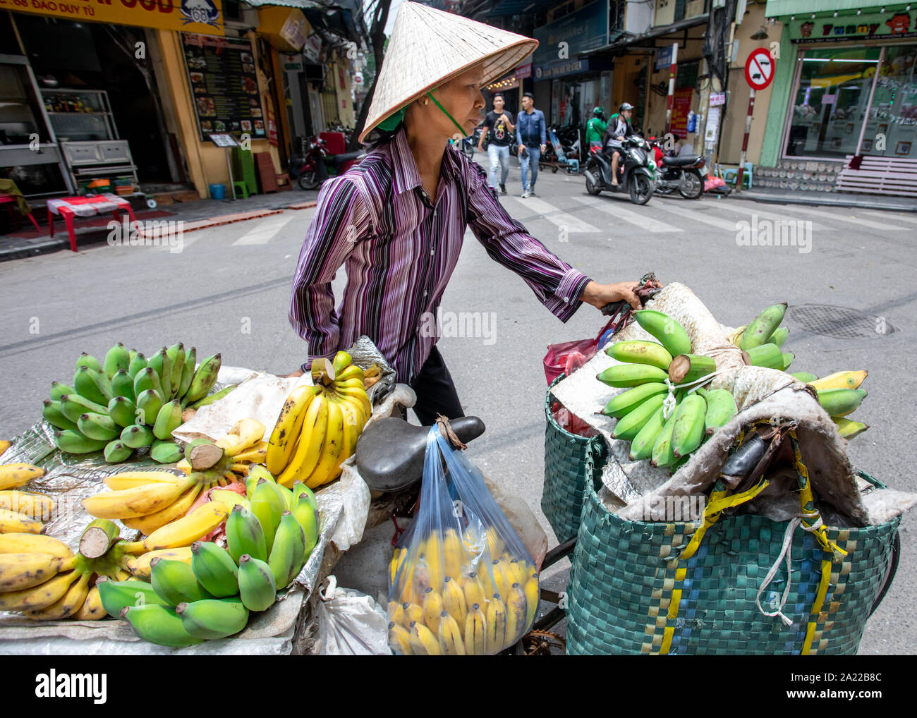 Woman selling fruit on street saigon hi-res stock photography and ...