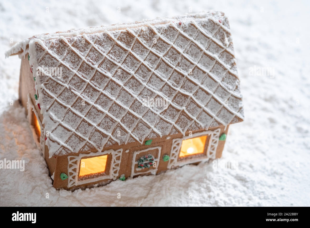 Gingerbread house in snow with twinkling silver light background Stock ...