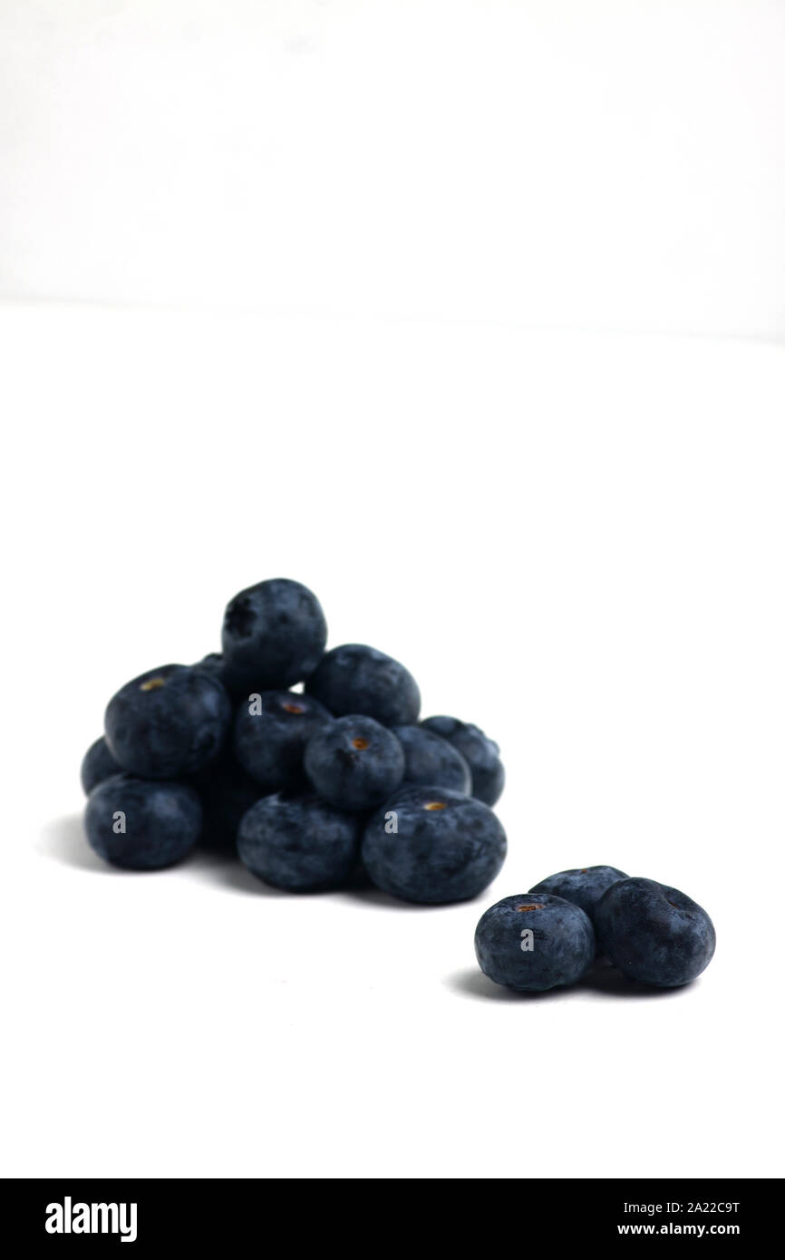 a pile of blueberry on white background. Image contains copy space ...