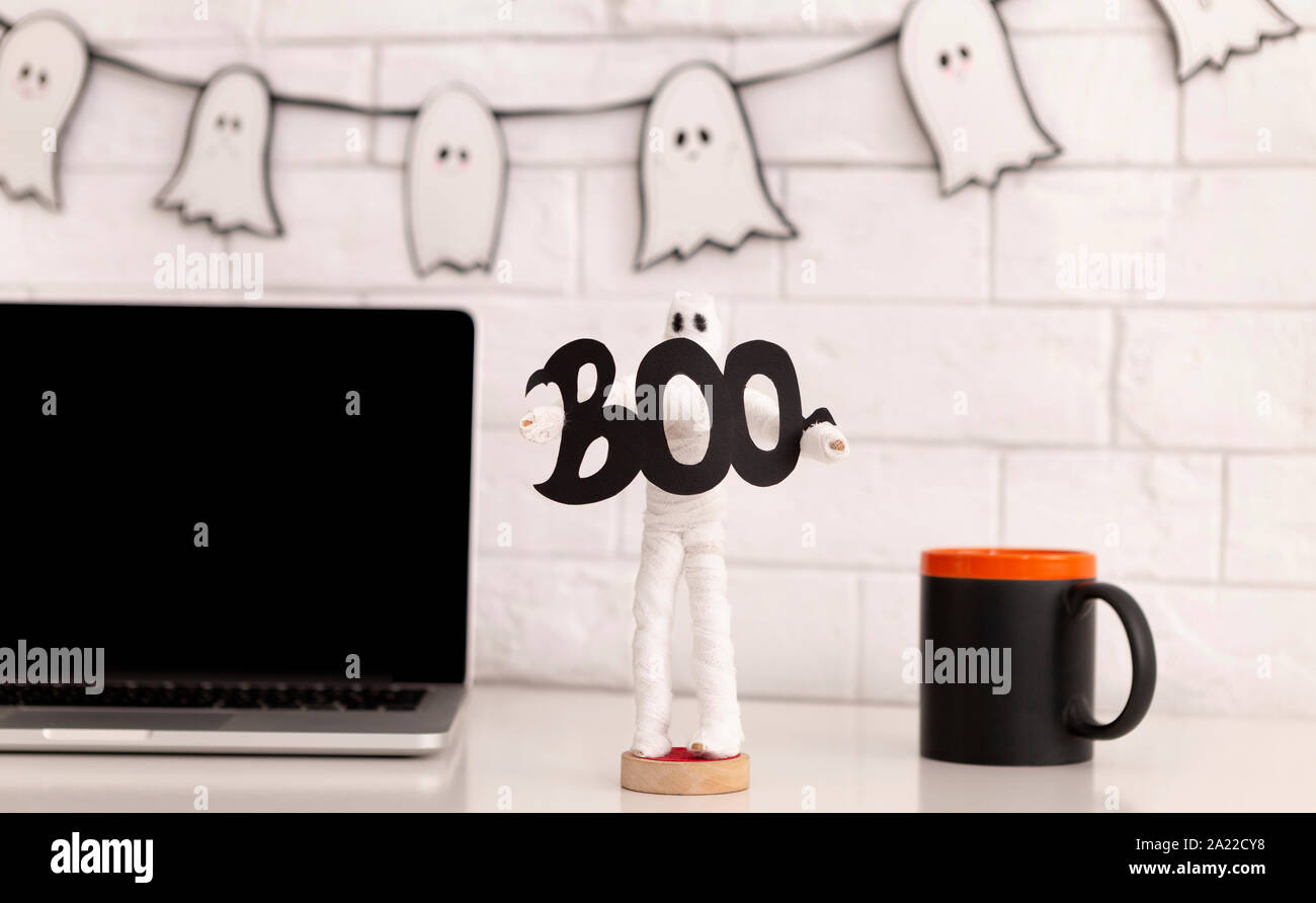 Halloween boo. Modern laptop with black blank screen for advertisement ...