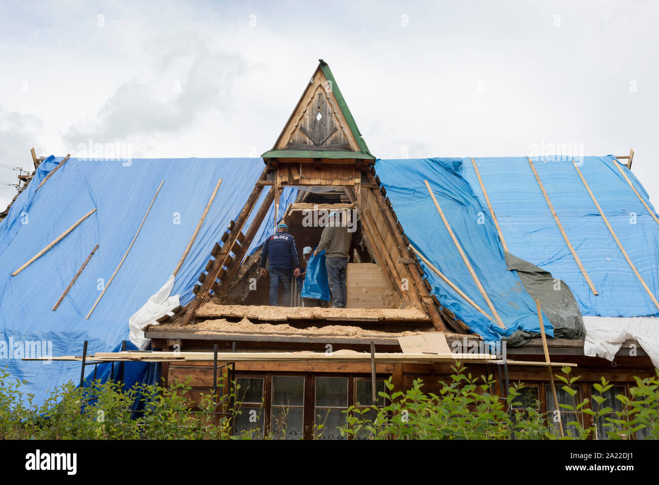 Workmen repair the timbers of a traditional Polish mountain house's ...