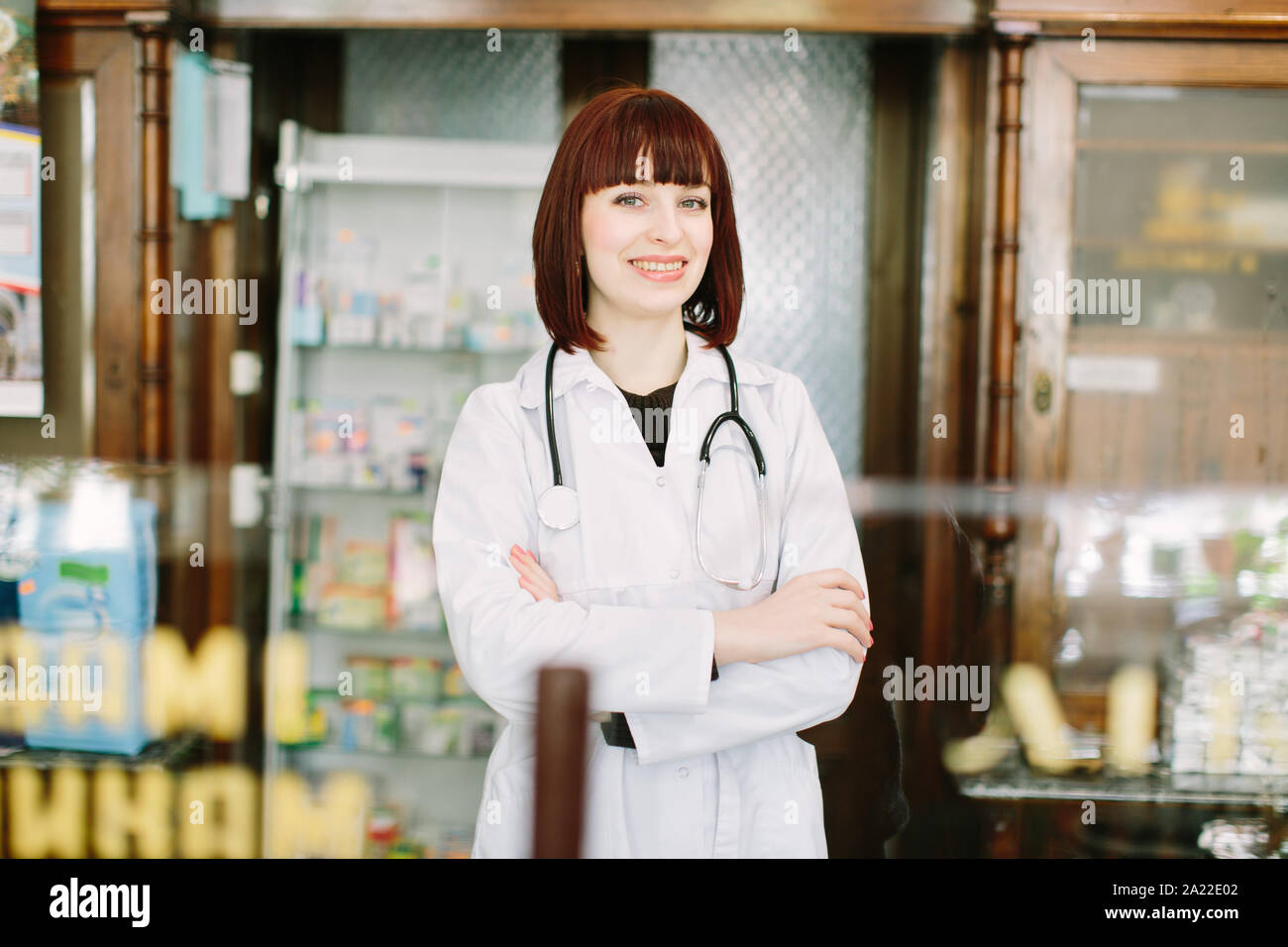 Horizontal portrait of a beautiful pharmacist smiling to the camera ...