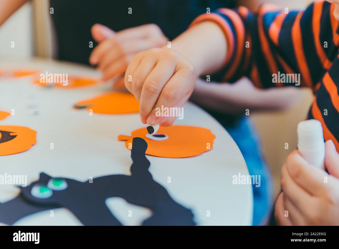 little boy making pumpkins head from paper halloween holidays Stock ...