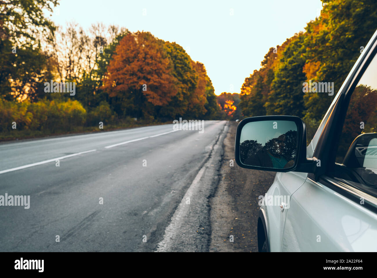 car at roadside of highway on sunrise autumn highway Stock Photo - Alamy