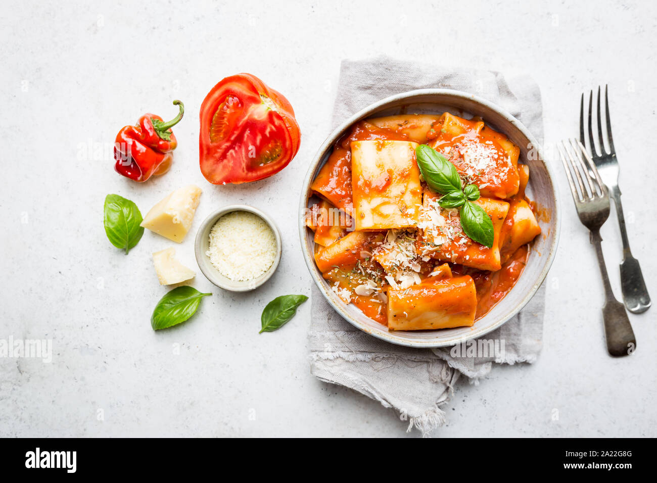 Pasta paccheri with tomato sauce and basil in a plate, top view Stock ...
