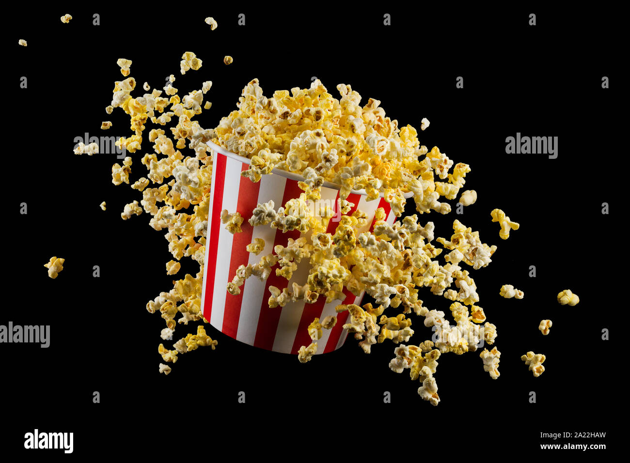 Flying popcorn from striped bucket isolated on black background Stock ...