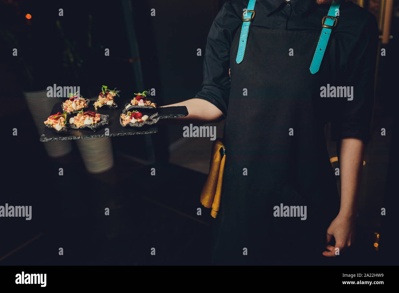 A waiter with a tray of snacks at a banquet or reception. Catering ...
