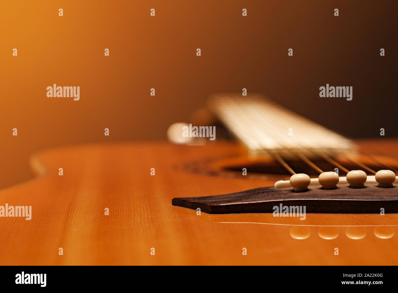 Acoustic guitar details. Guitar bridge, bridge pins, string and neck ...