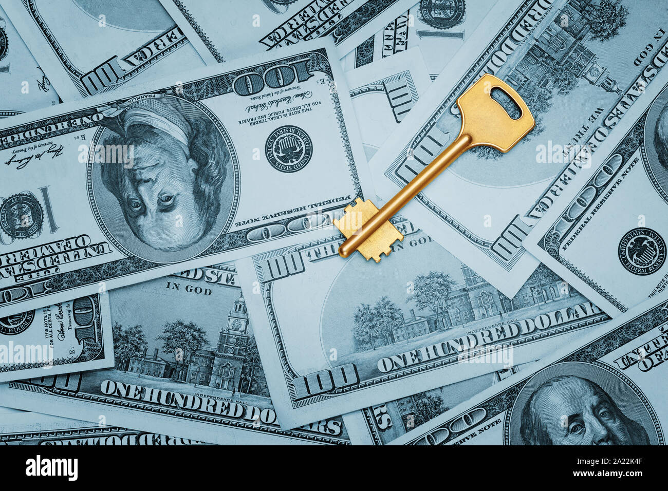 Golden key on 100 dollar bills. Flat lay. Key to success, wealth ...
