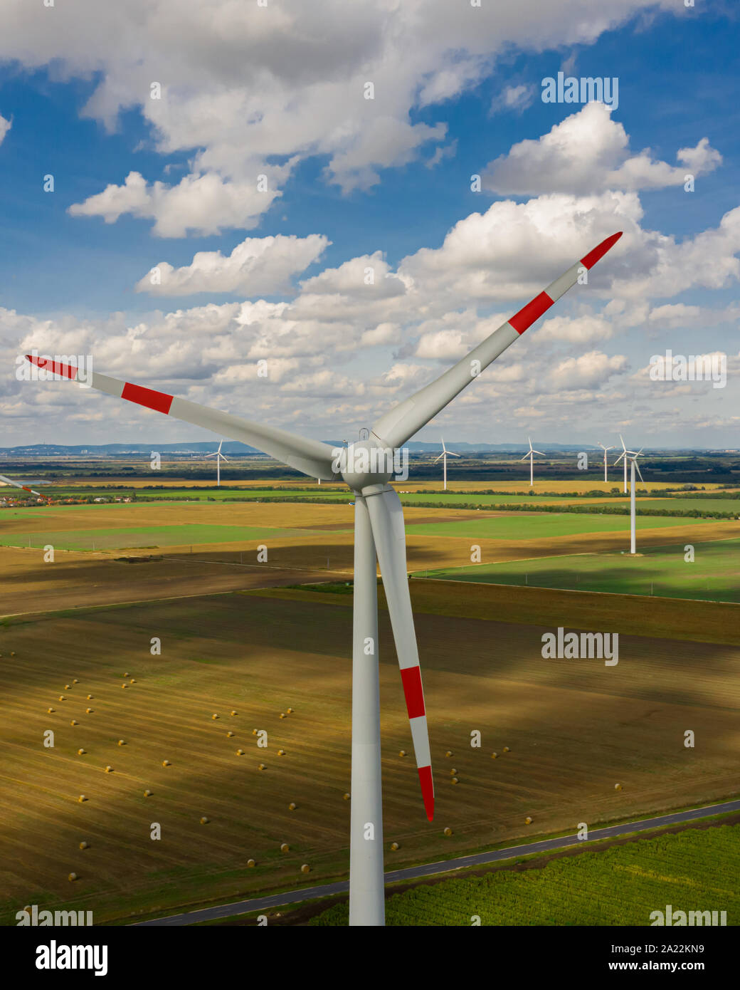 Wind turbine in field. Wind energy converter Stock Photo - Alamy