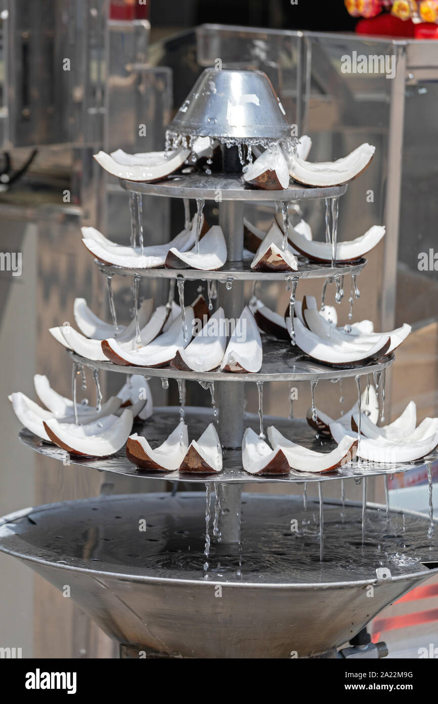 Pouring Water Over Pieces of Coconut Tower Stock Photo - Alamy