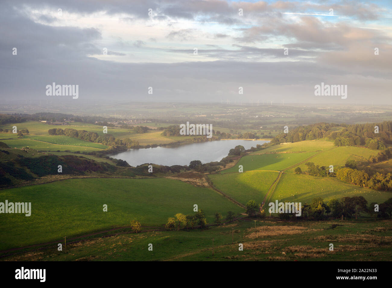 Scottish morning landscape with a lake, fields and hills. West Lothian ...