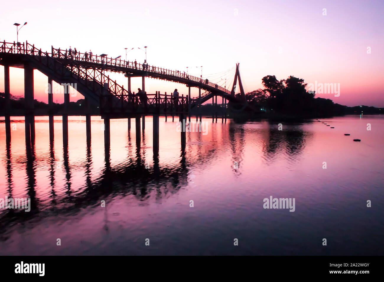 Bridge at sunset .Vanilla sky in blur and pink shade with crowd on the ...
