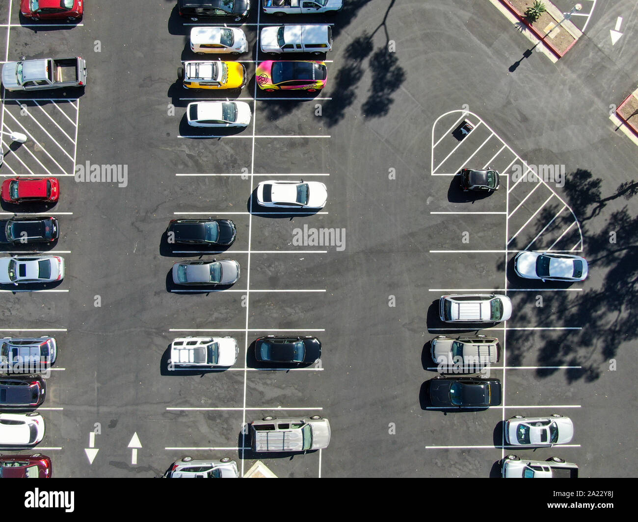 Aerial top view of parking lot with with varieties of colored vehicles ...