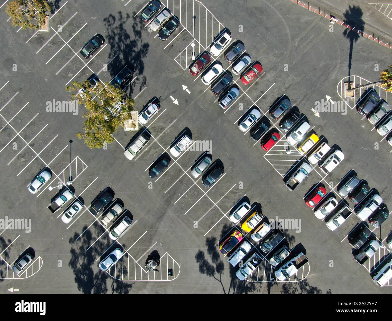 Aerial top view of parking lot with with varieties of colored vehicles ...