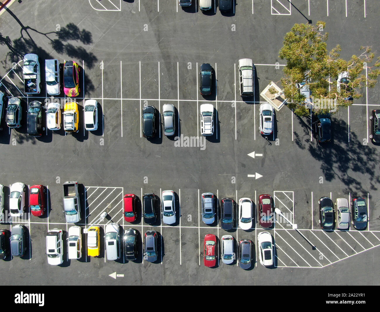 Aerial top view of parking lot with with varieties of colored vehicles ...