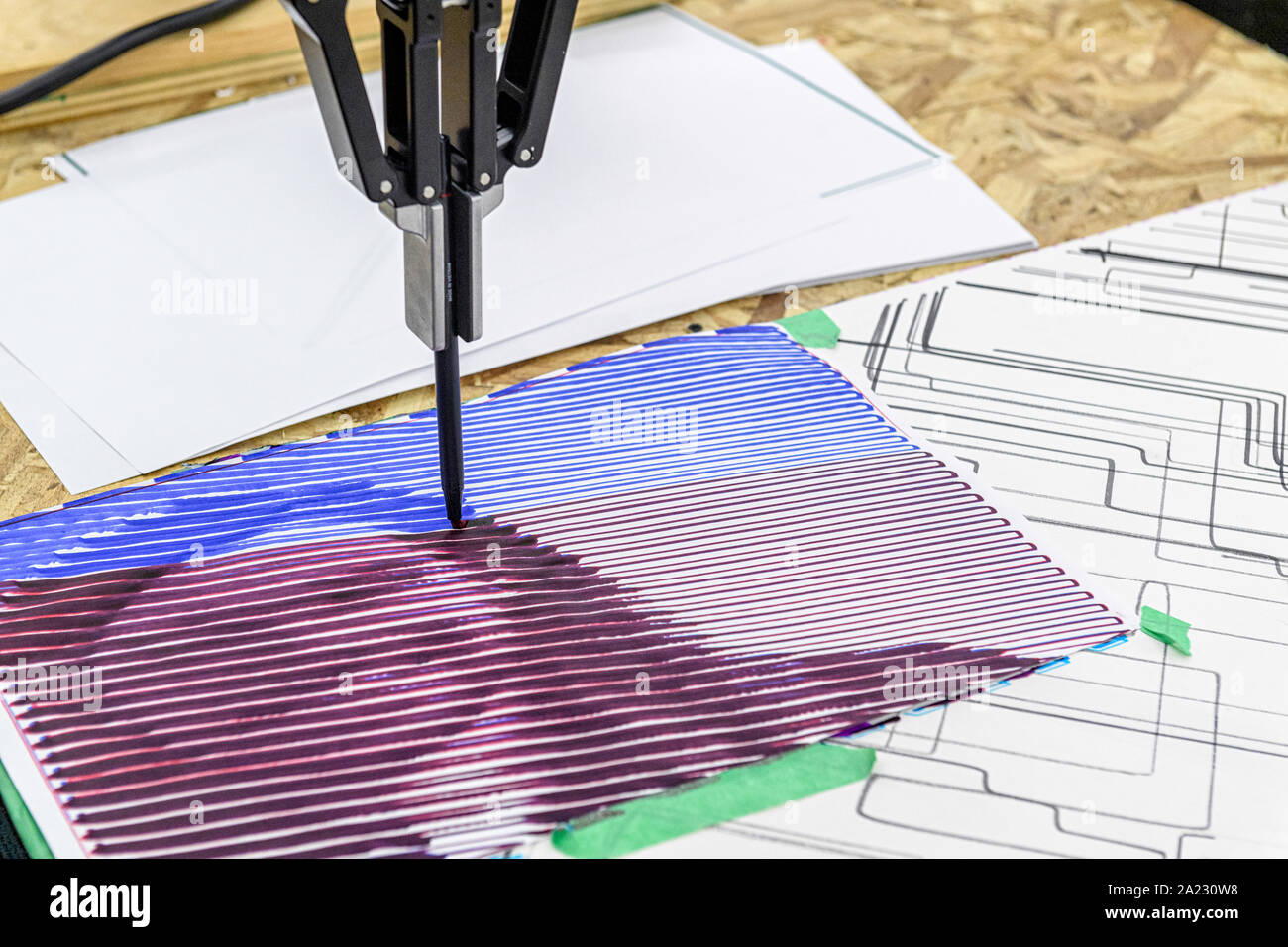 Robotic arm creating a portrait on paper from a digital file Stock ...