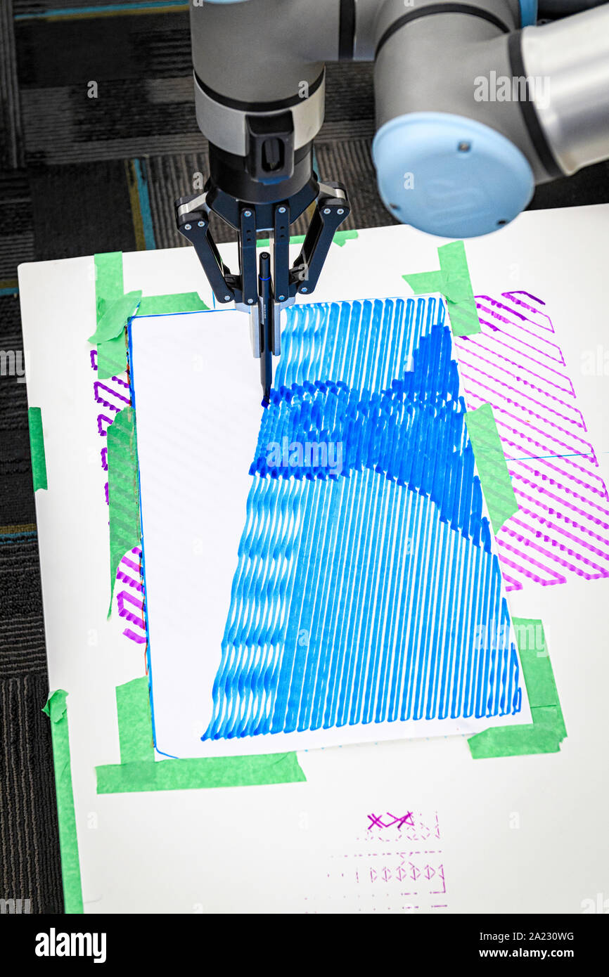 Robotic arm creating a portrait on paper from a digital file Stock ...