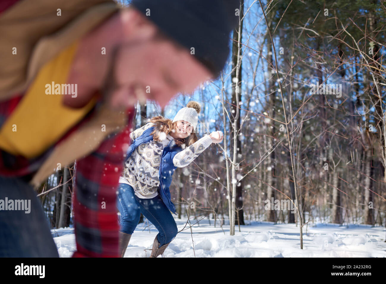 Family of a mother, father and boy child having fun in snow during the ...